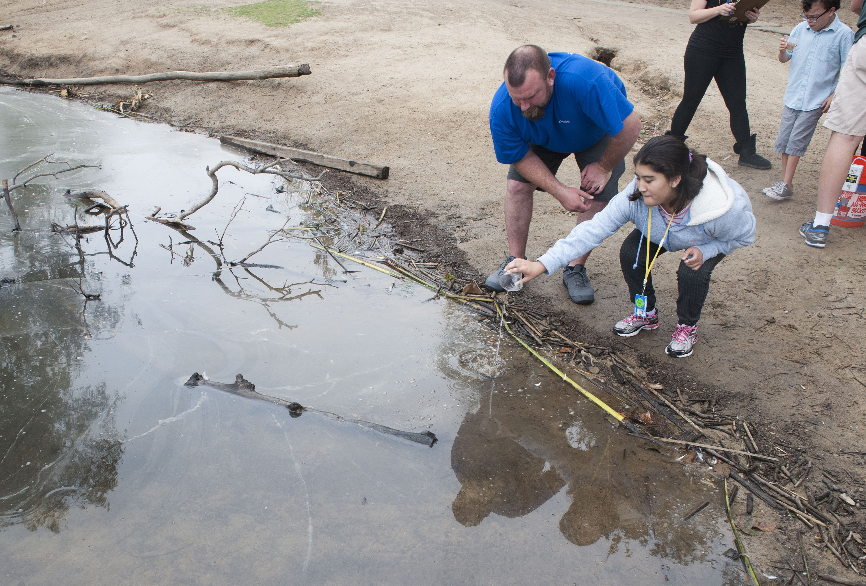 Students release fish they have raised and fed