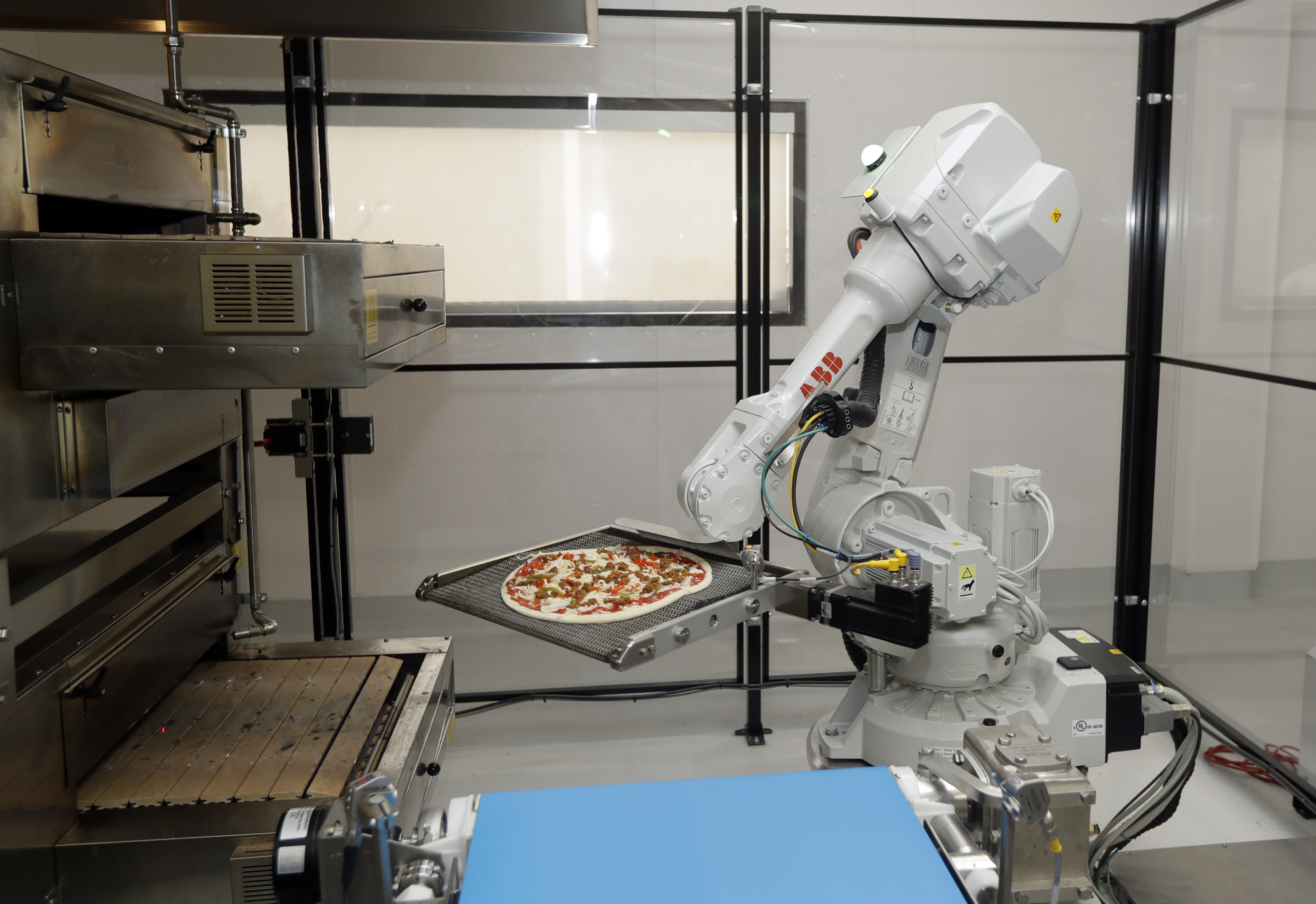 Robots revolutionizing the making of pizza pies