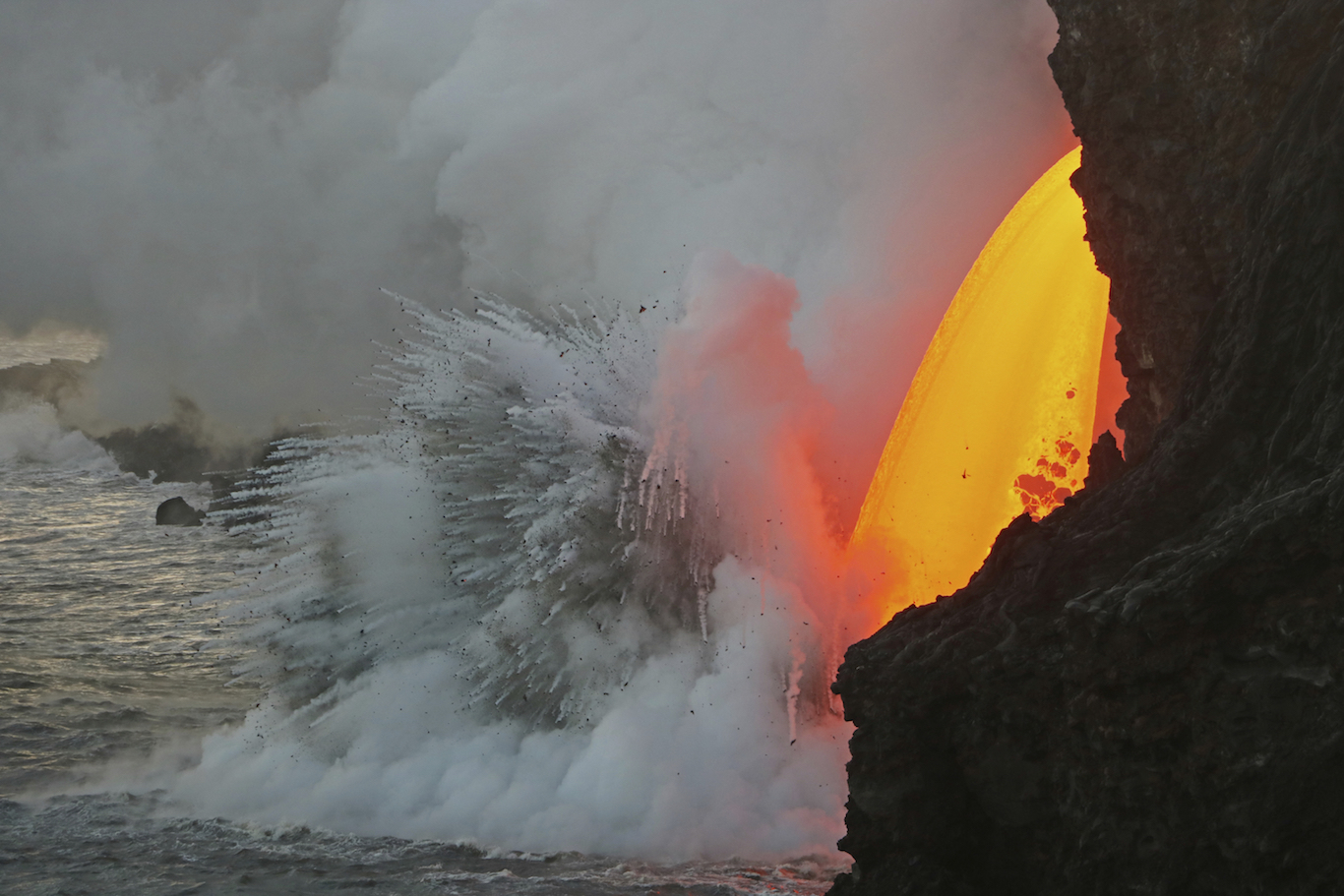 Hot lava flowing into the cool ocean off Hawaii gives quite a show
