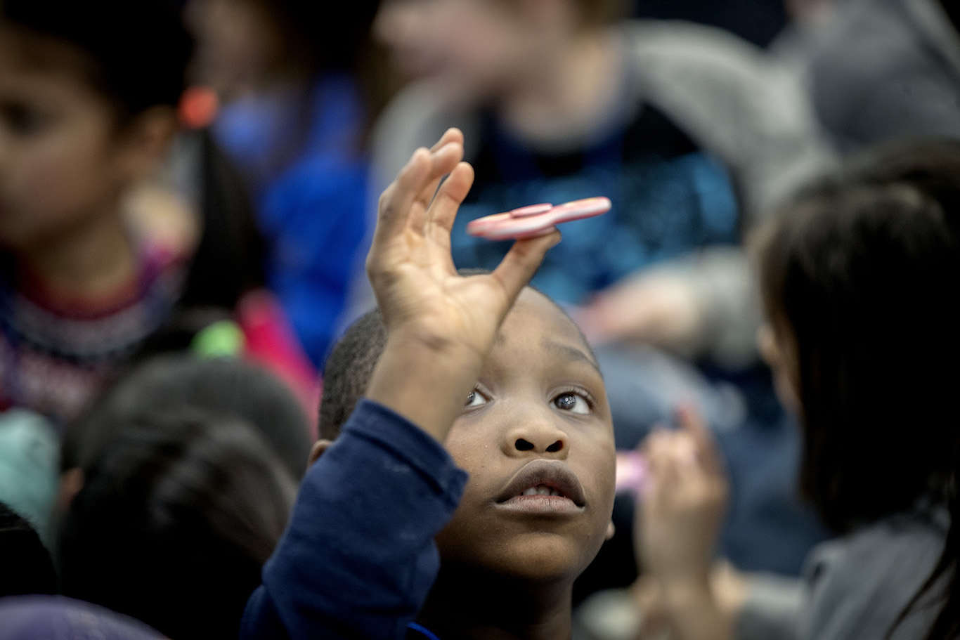 A minute to spin it: School tries to set record for fidget spinning